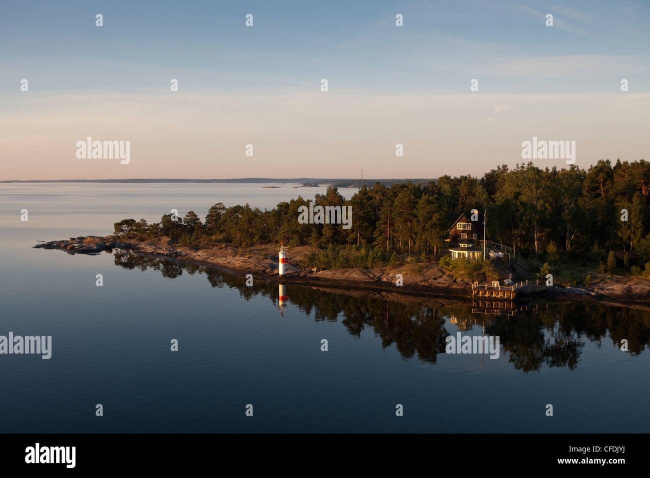 Lighthouse and idyllic house along coastline at entrance to Stockholm ...