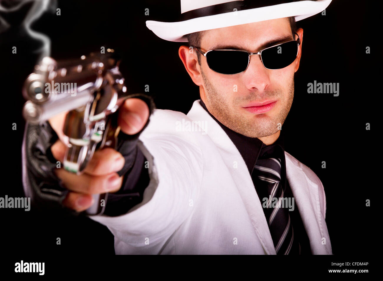 View of a white suit gangster man holding a gun Stock Photo - Alamy