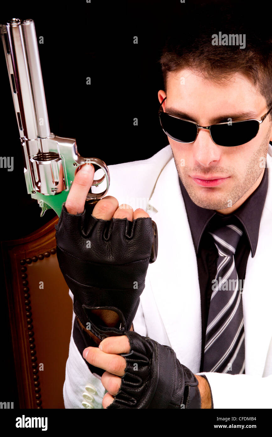 View of a white suit gangster man holding a gun Stock Photo - Alamy