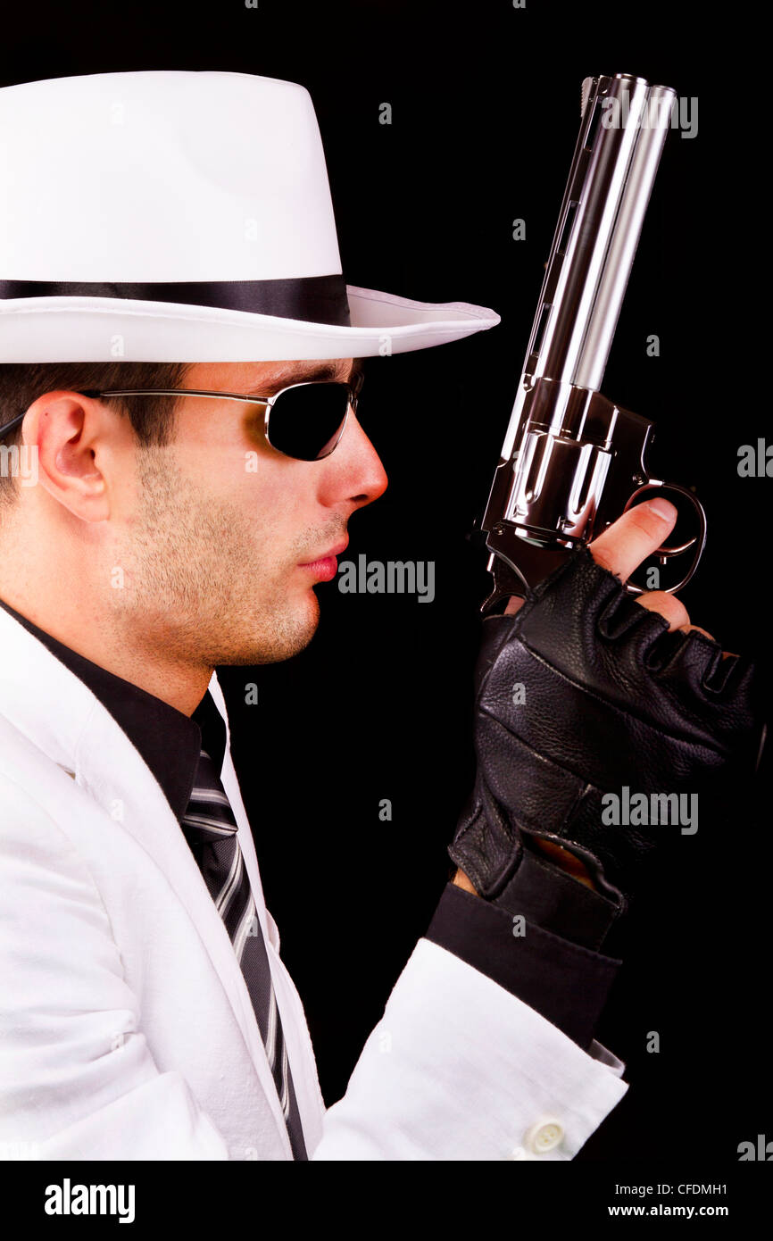 View of a white suit gangster man holding a gun Stock Photo - Alamy