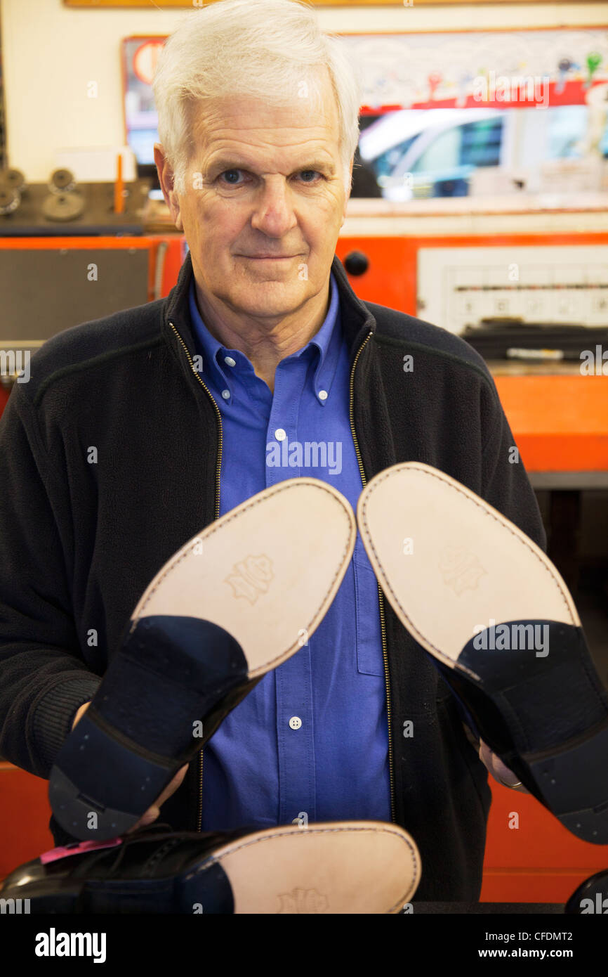 New leather soles & heels on shoes on display in shoe repair shop ...
