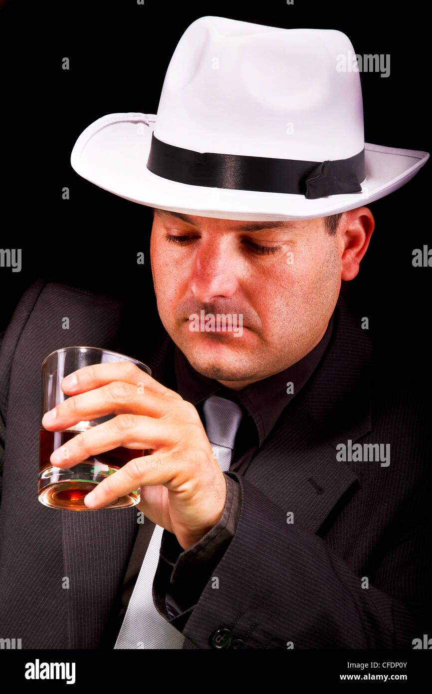 View of a gangster man with white hat drinking some liquor Stock Photo ...