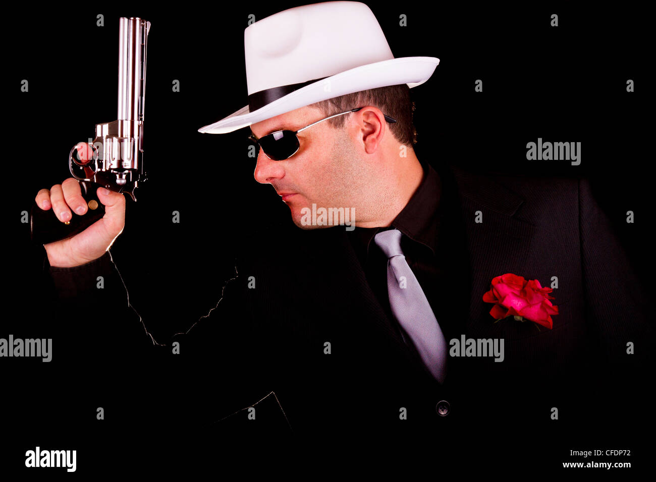 View of a dark suit gangster man holding a gun Stock Photo - Alamy