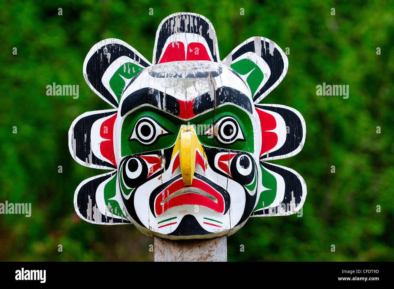 A weathered sun mask totem at a burial ground in Alert Bay on Cormorant ...