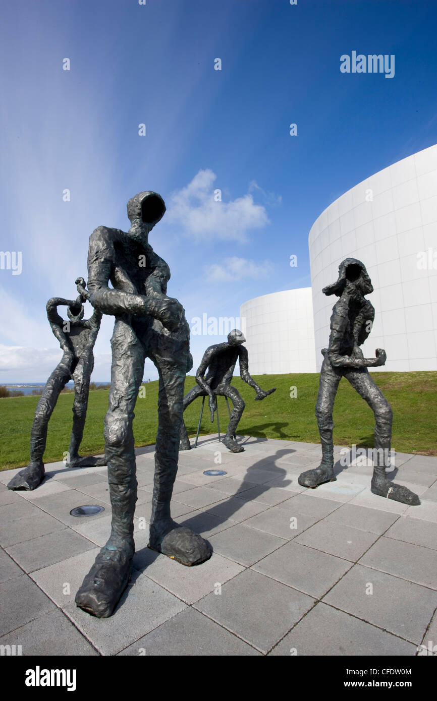 Modern sculpture of four figures playing imaginary musical instruments ...