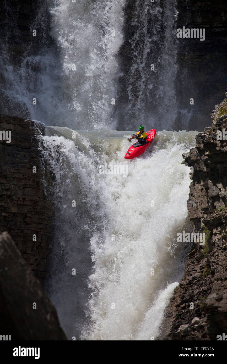 A male kayaker drops a large waterfall on the Bighorn River, Nordegg ...
