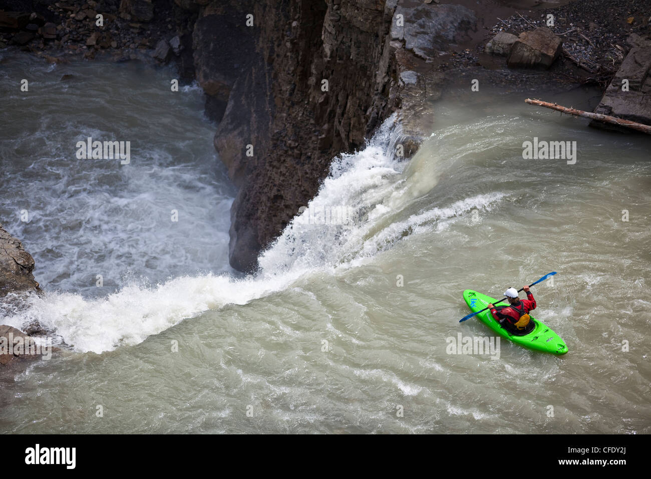A male kayaker drops a large waterfall on the Bighorn River, Nordegg ...