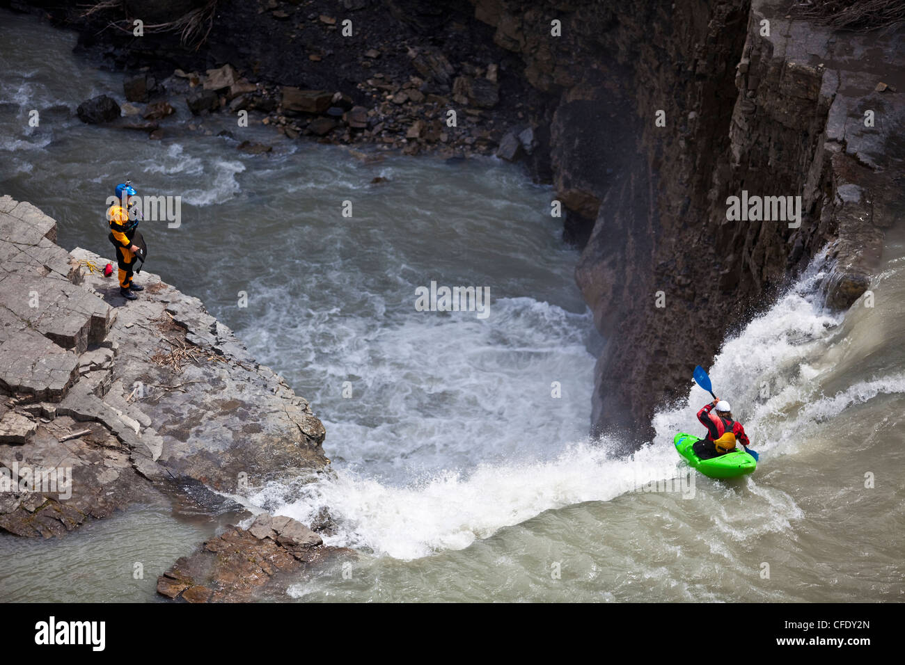 A male kayaker drops a large waterfall on the Bighorn River, Nordegg ...