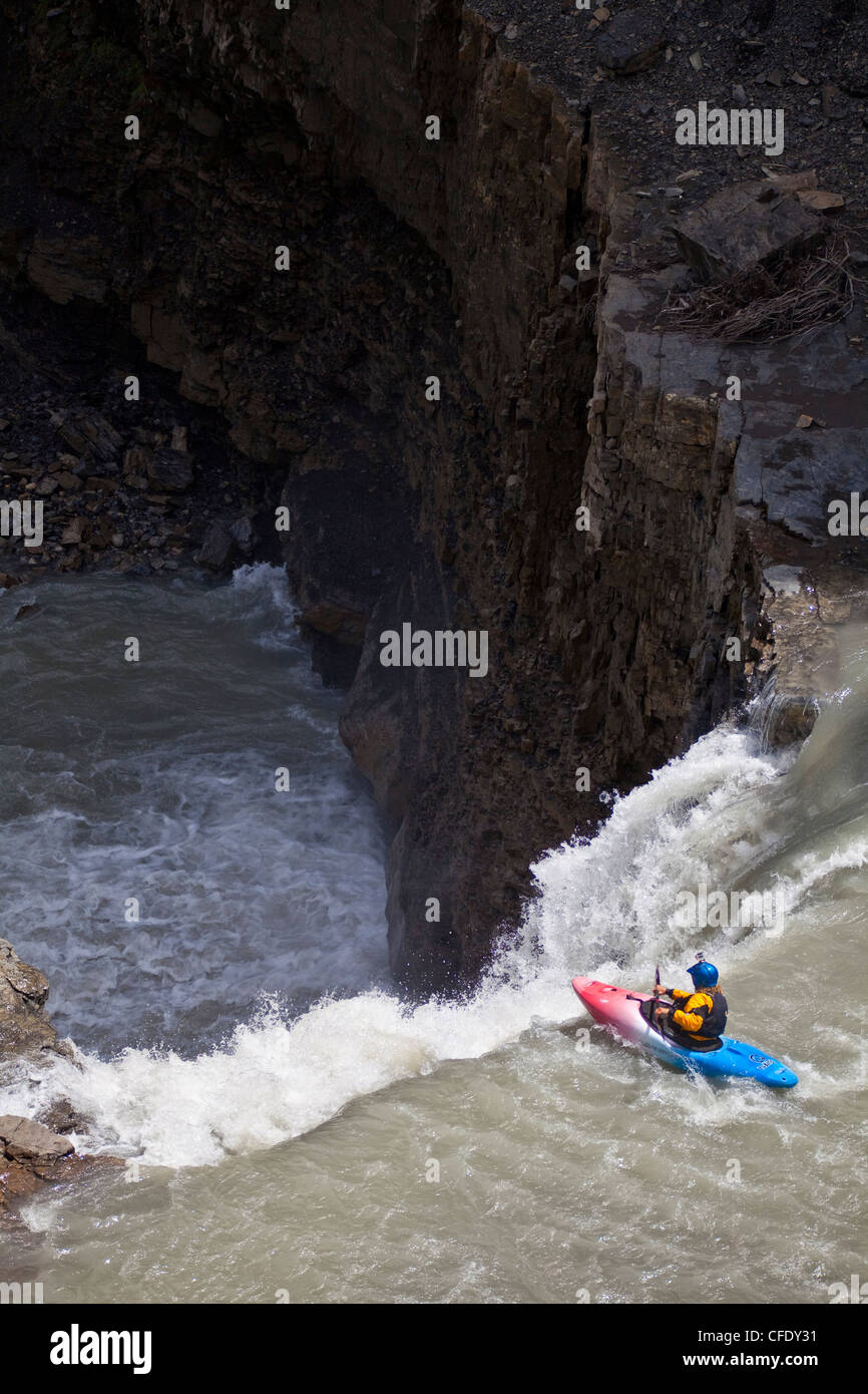 A male kayaker drops a large waterfall on the Bighorn River, Nordegg ...