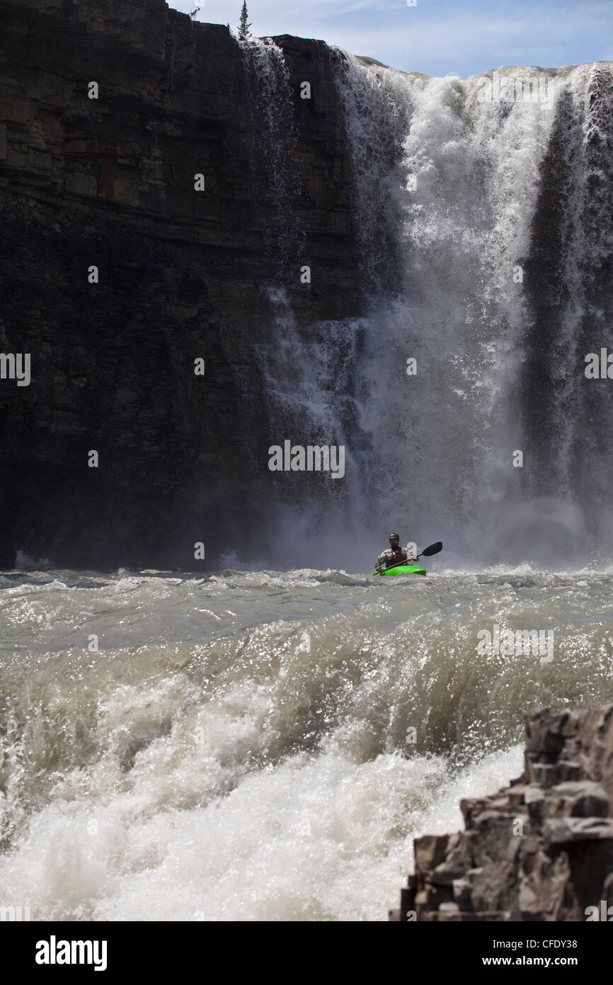 A male kayaker drops a large waterfall on the Bighorn River, Nordegg ...
