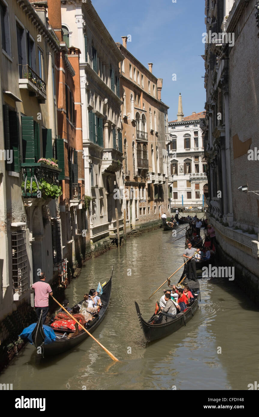 Gondolas passing in a narrow canal in Venice, UNESCO World Heritage ...