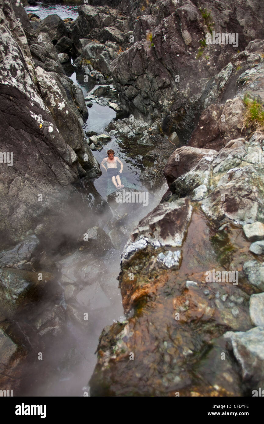 A middle aged man enjoys Hot Springs Cove, Maquinna Provincial Park ...