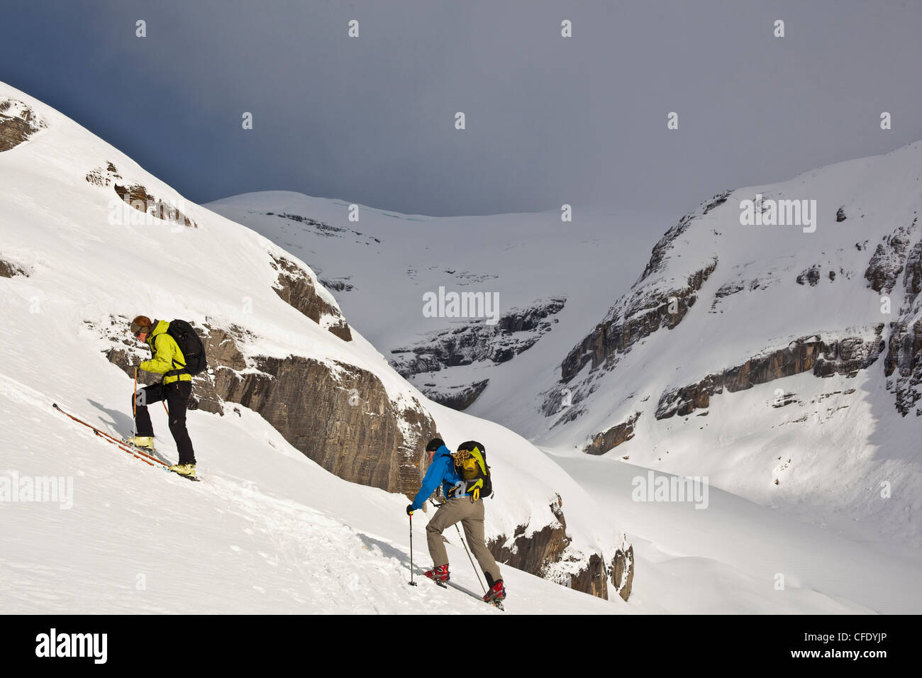 Two backcountry skiers skinning up a steep slope. Icefall Lodge ...