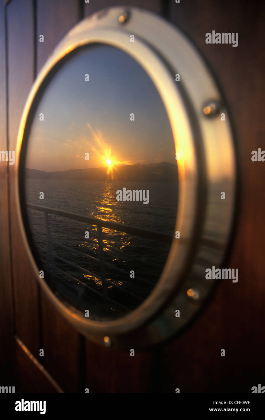 golden sunset reflects porthole window Windstar's Stock Photo - Alamy
