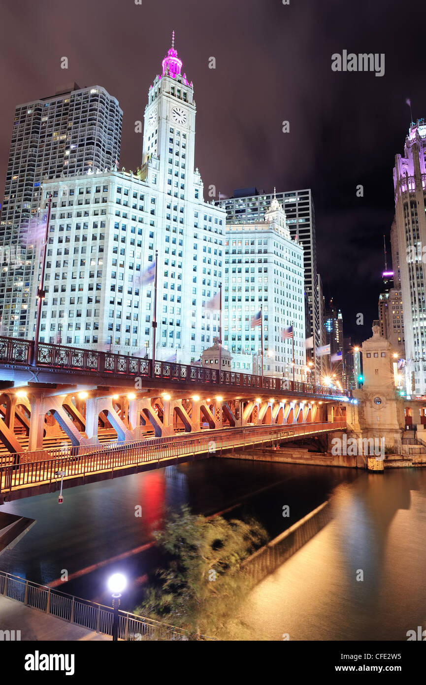 Chicago River Walk with urban skyscrapers and bridge illuminated with ...
