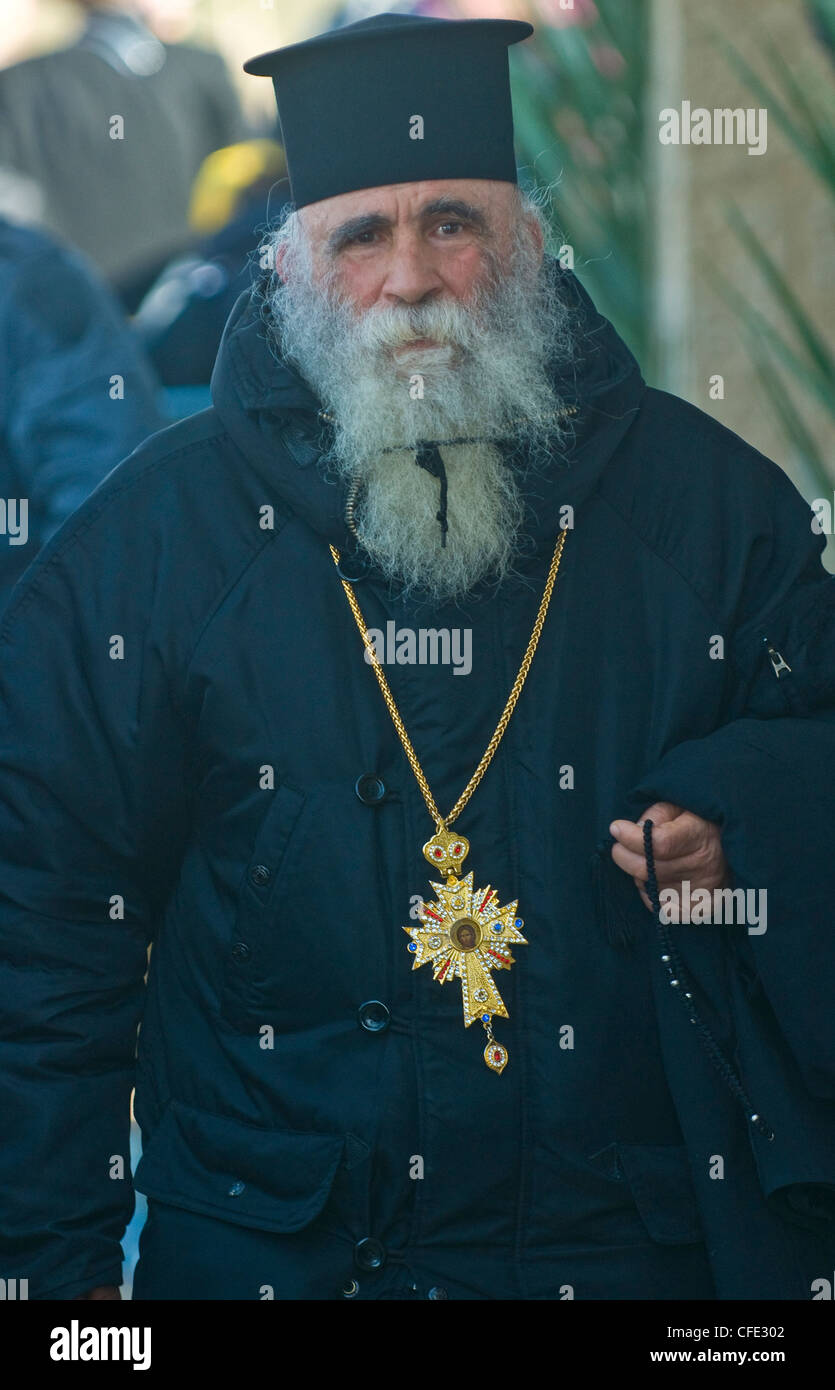 Portrait of Orthodox priest participates in the baptising ritual during ...