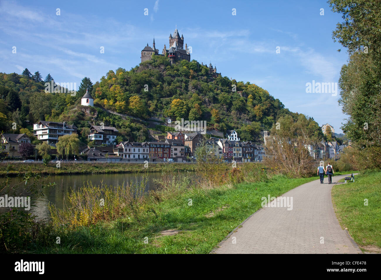 Hiker walking on trail along the Moselle river, Cochem castle on the ...