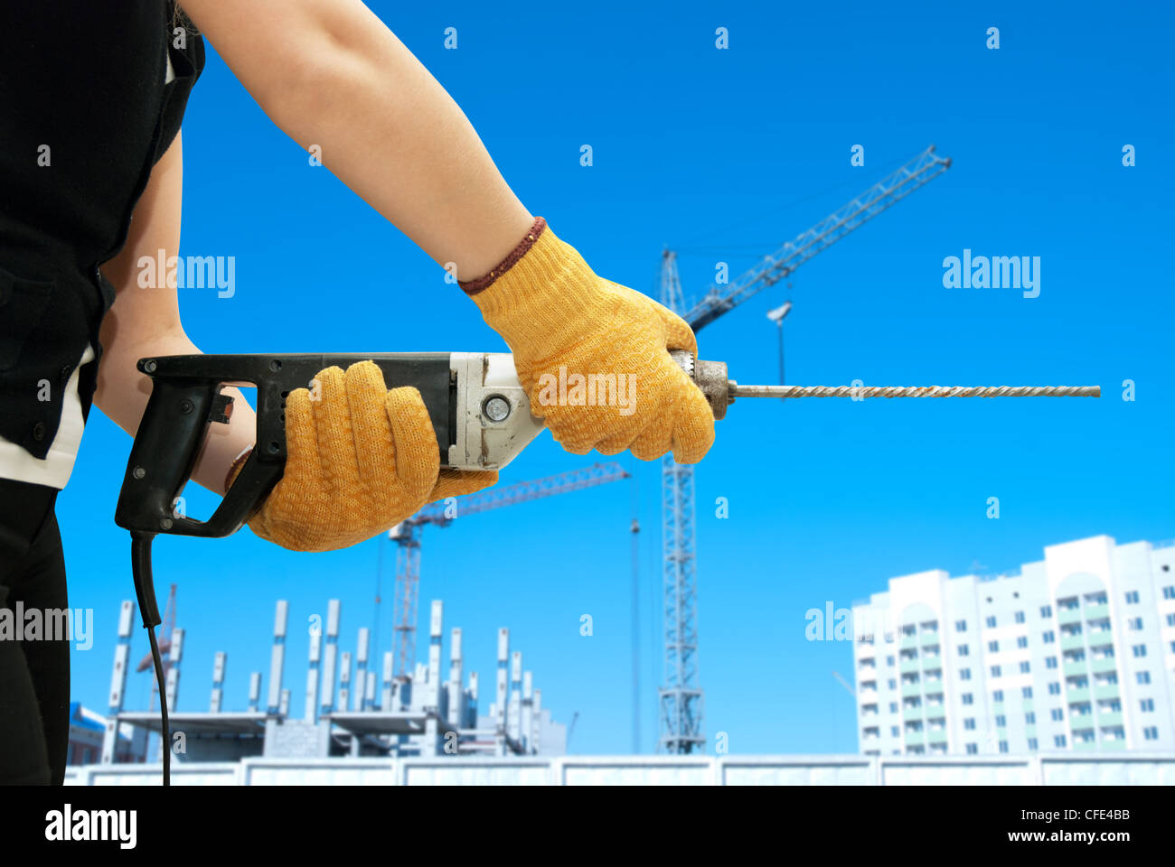 Construction worker building with drill on a building background Stock ...