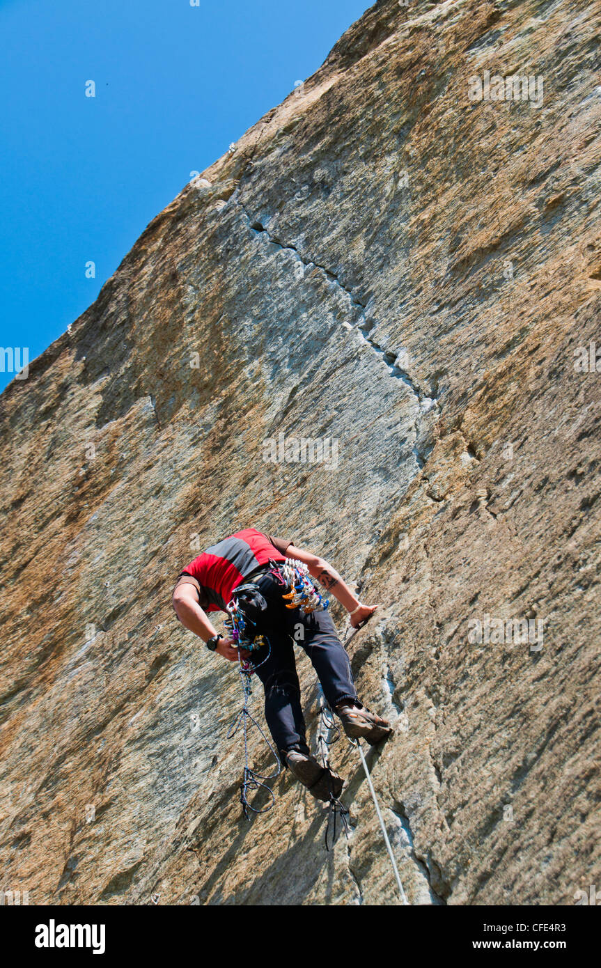 climber while climbing a vertical rock wall Stock Photo - Alamy