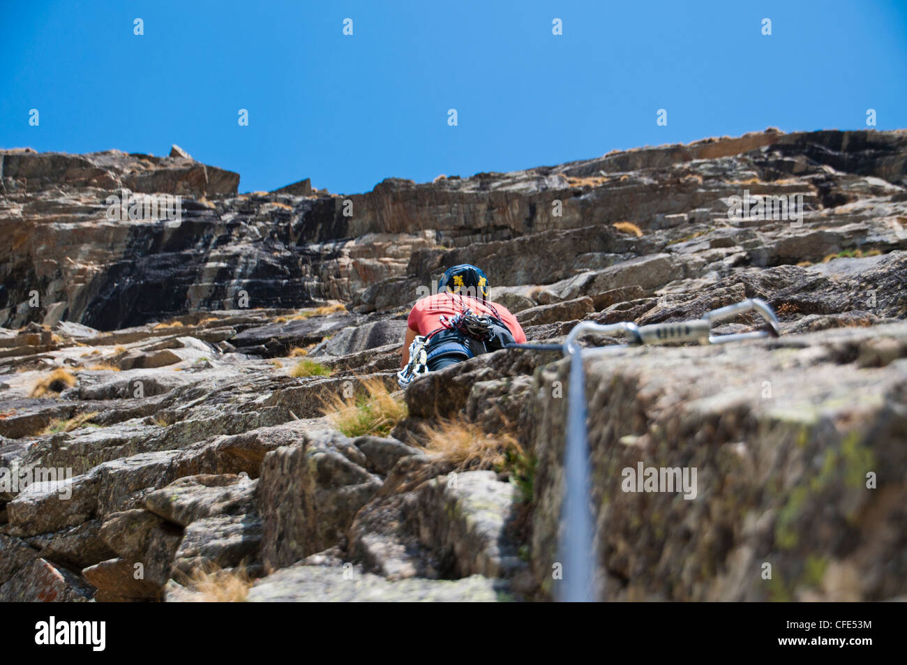 climber while climbing a vertical rock wall Stock Photo - Alamy
