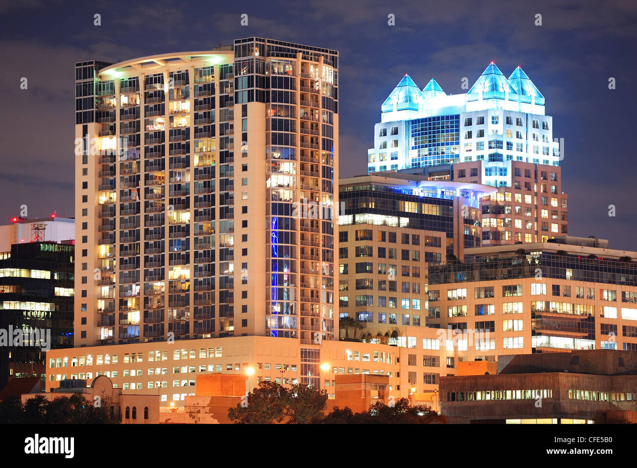 Urban architecture with Orlando downtown skyline over Lake Eola at dusk ...
