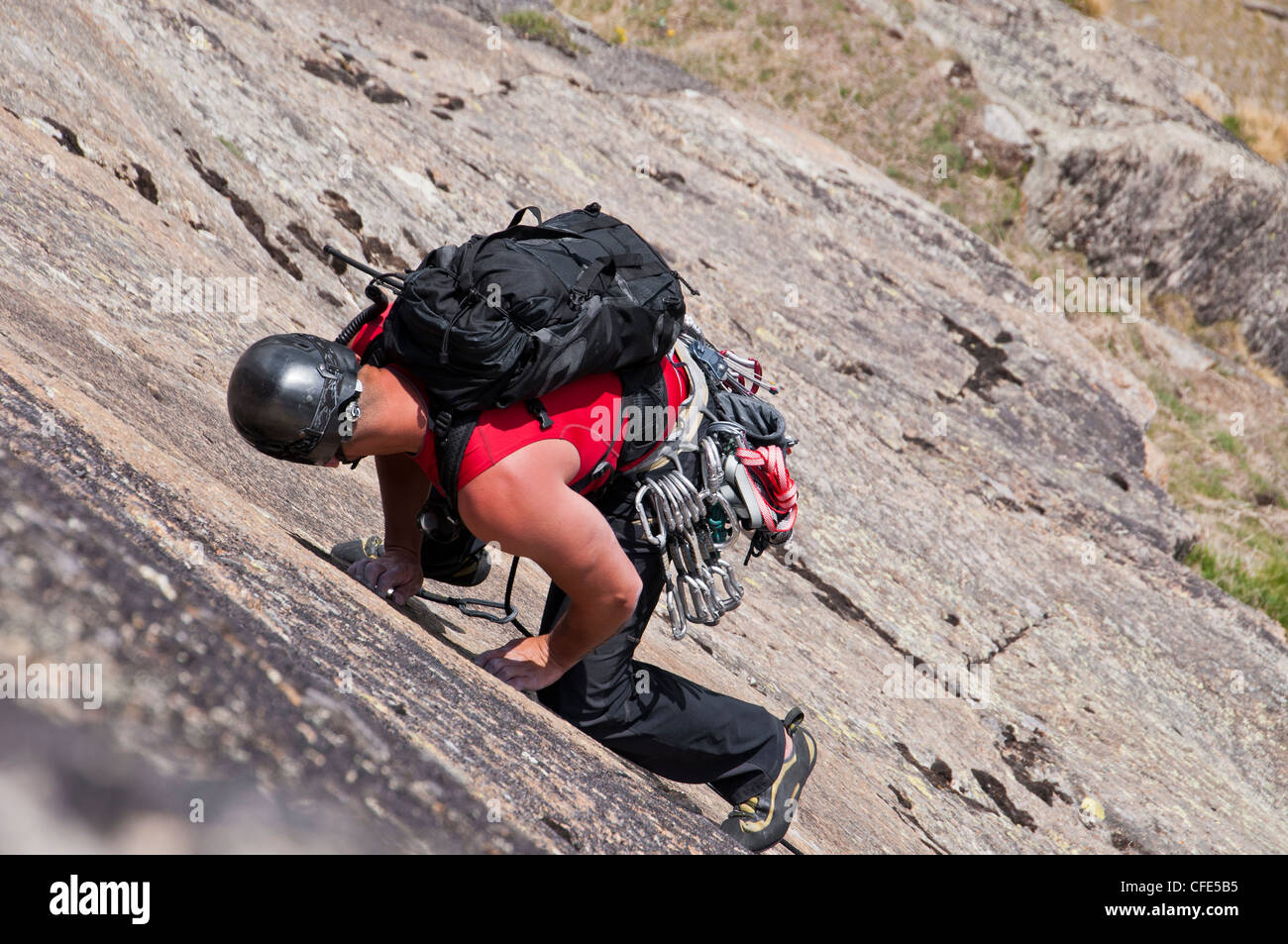 climber while climbing a vertical rock wall Stock Photo - Alamy