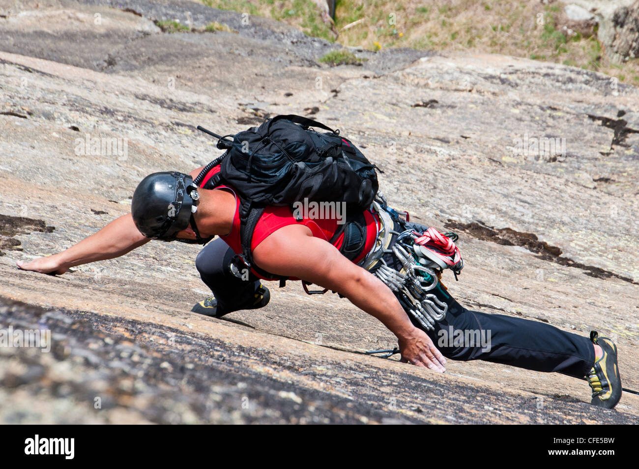 climber while climbing a vertical rock wall Stock Photo - Alamy