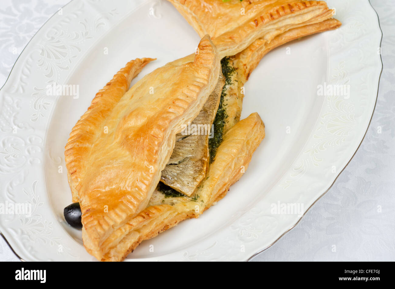 tasty dish of trout fish baked with greens at dough Stock Photo - Alamy