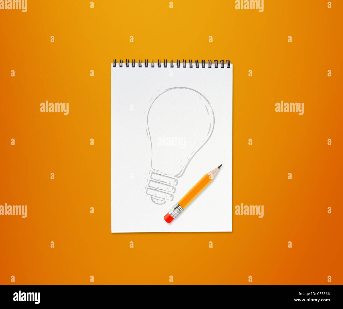 pencils and notepad and drawing light bulb on orange background Stock ...