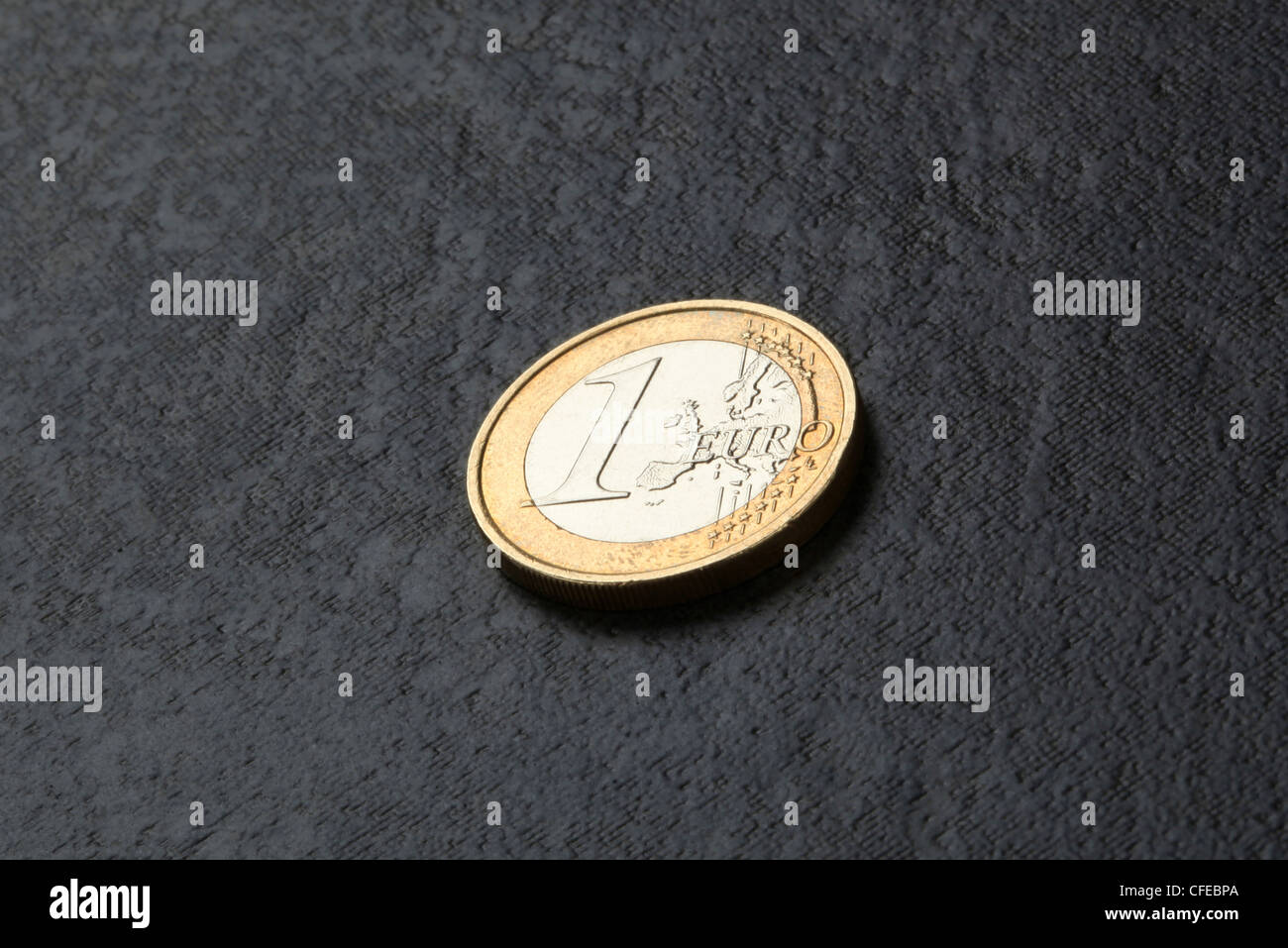 Euro coin on black background Stock Photo - Alamy