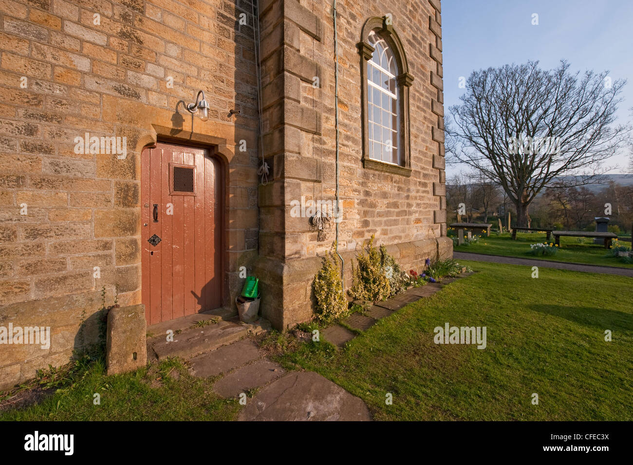 External doorway entrance (wooden door closed) at base of church tower ...