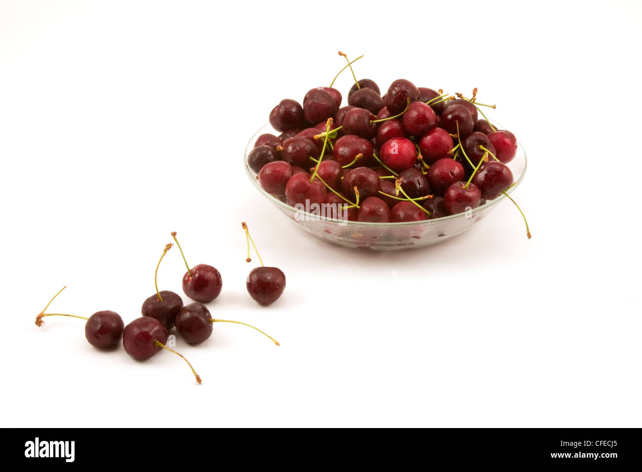 Bowl of cherries on white background Stock Photo - Alamy