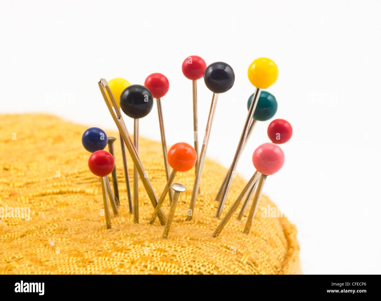 Straight pins and Cushion on white background Stock Photo - Alamy