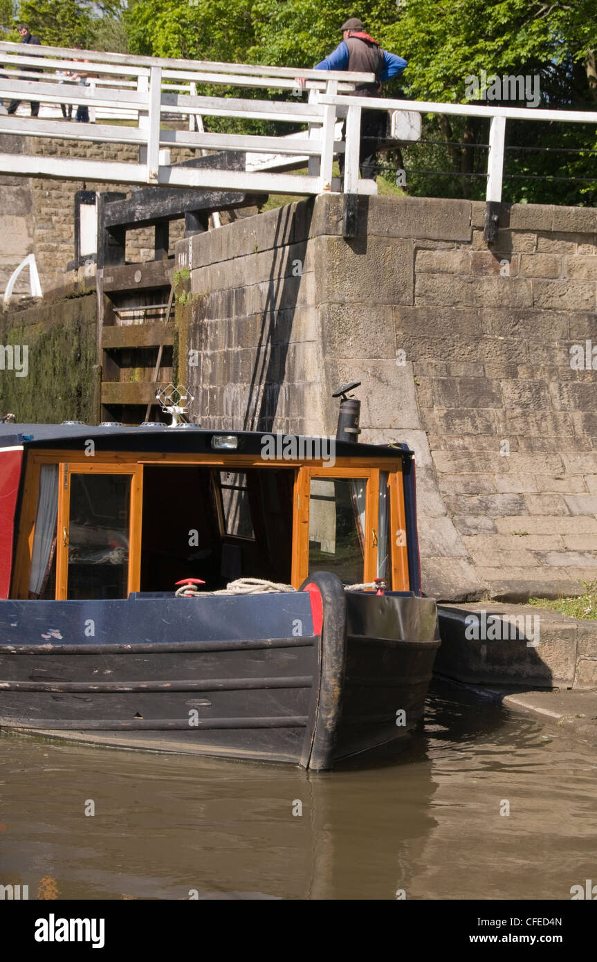 Bow (front) of narrowboat sailing & navigating out of bottom lock of ...