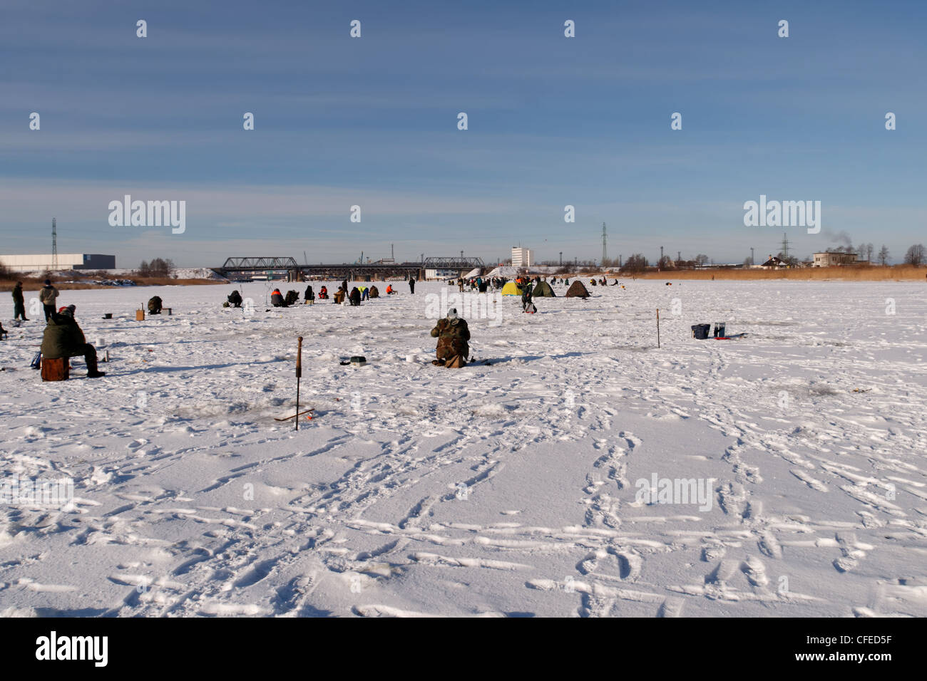 ice fishermens fishing on a frozen river Stock Photo - Alamy