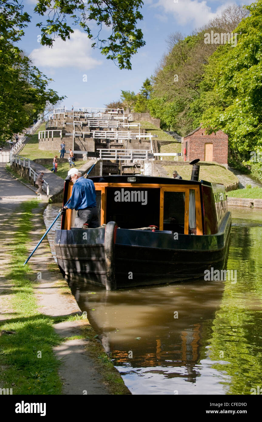 Man male on board canal boat pushing off with pole hi-res stock ...