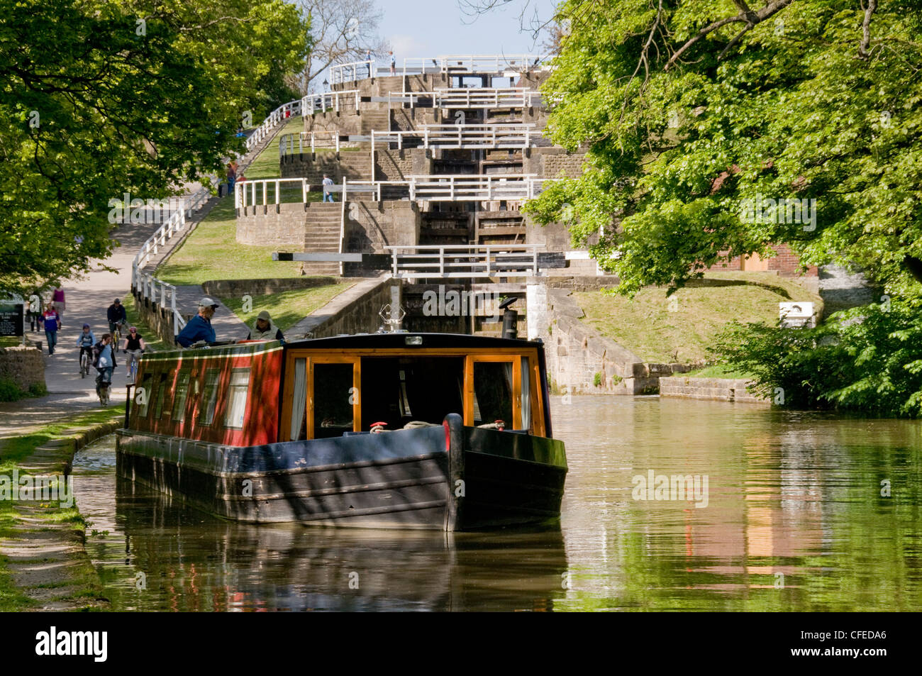 Narrowboat travelling on scenic rural waterway (Five Rise Locks, Leeds ...