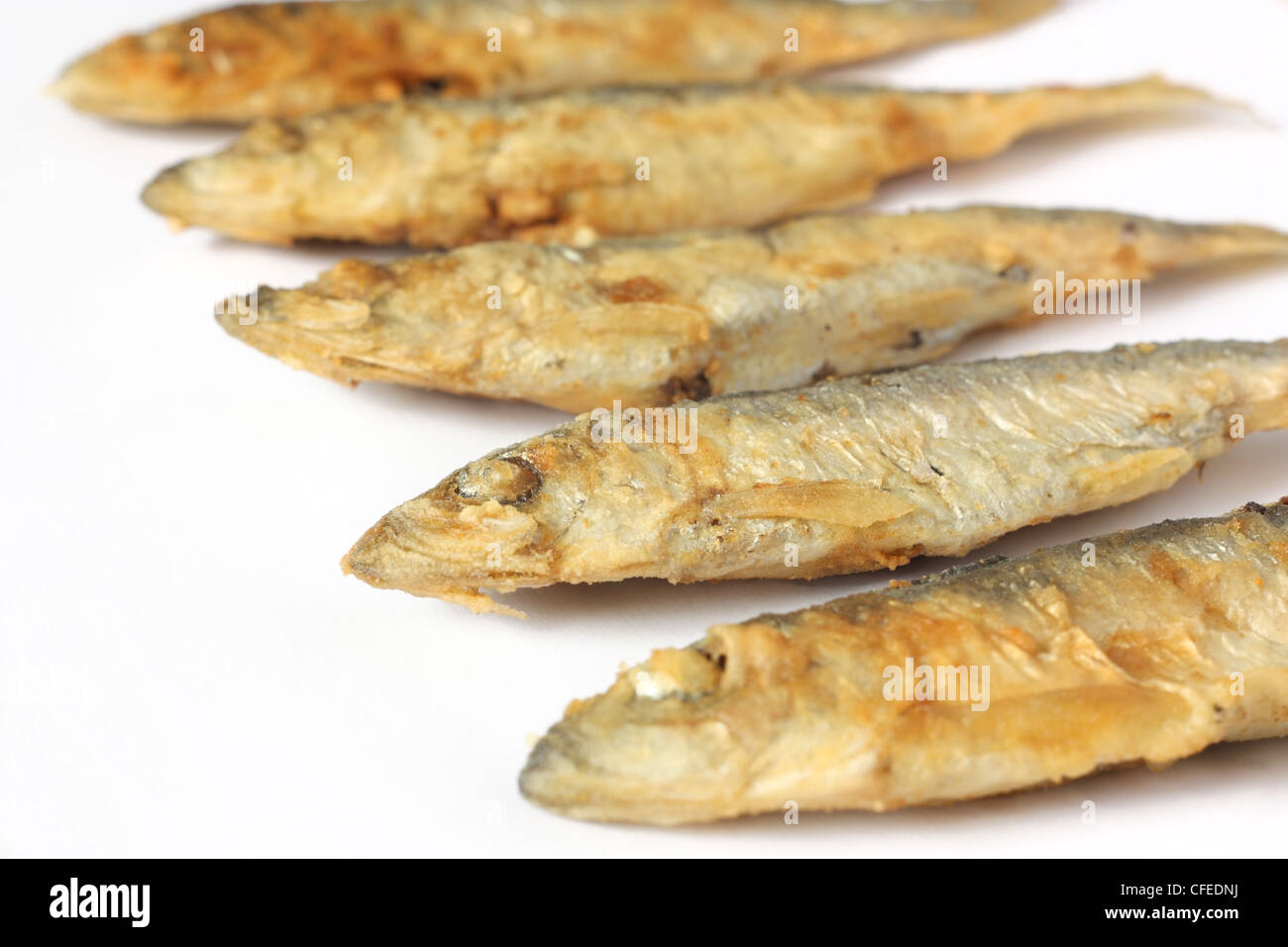 Five fried fish on a white background Stock Photo - Alamy