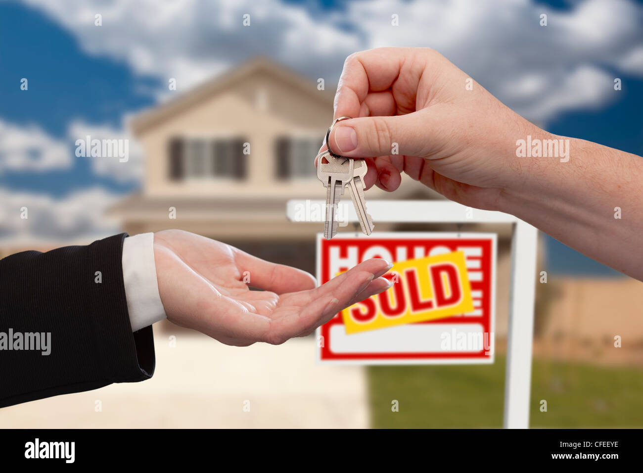 Handing Over the House Keys in Front of Real Estate Sign and Sold New ...