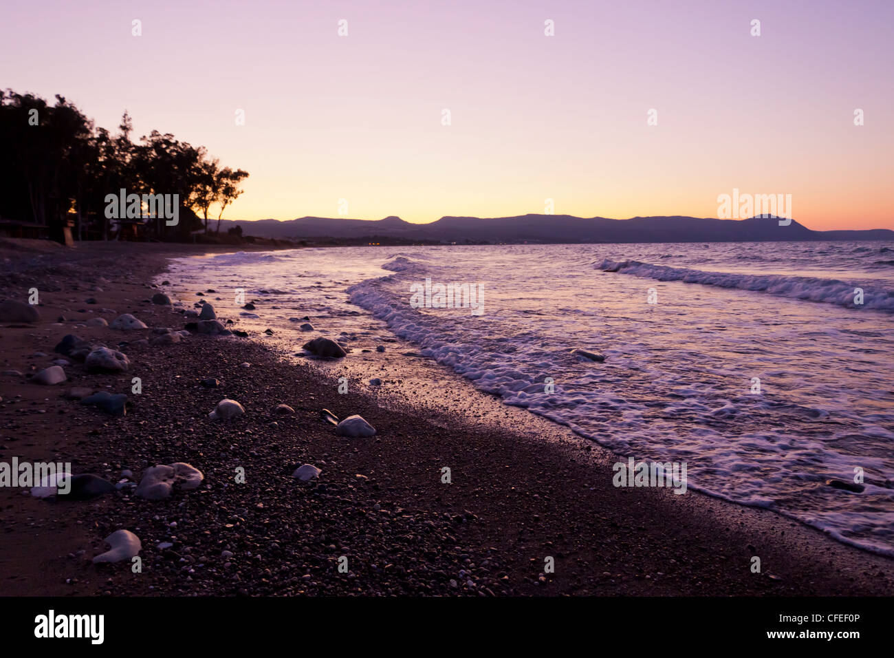 Purple sunset at Polis campsite beach Stock Photo - Alamy