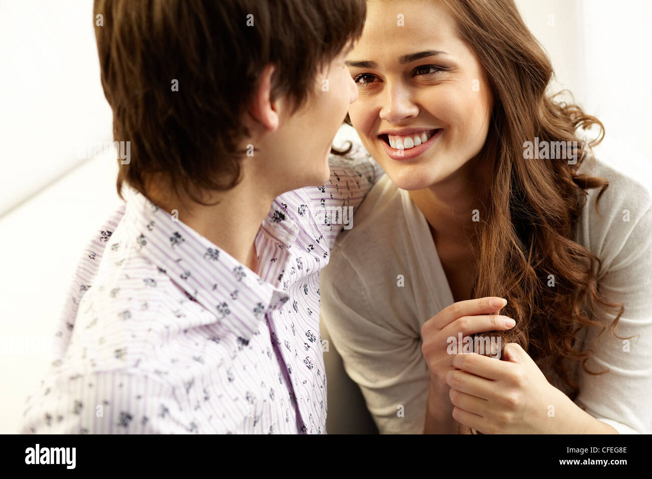 Young people embracing and smiling at each other Stock Photo - Alamy