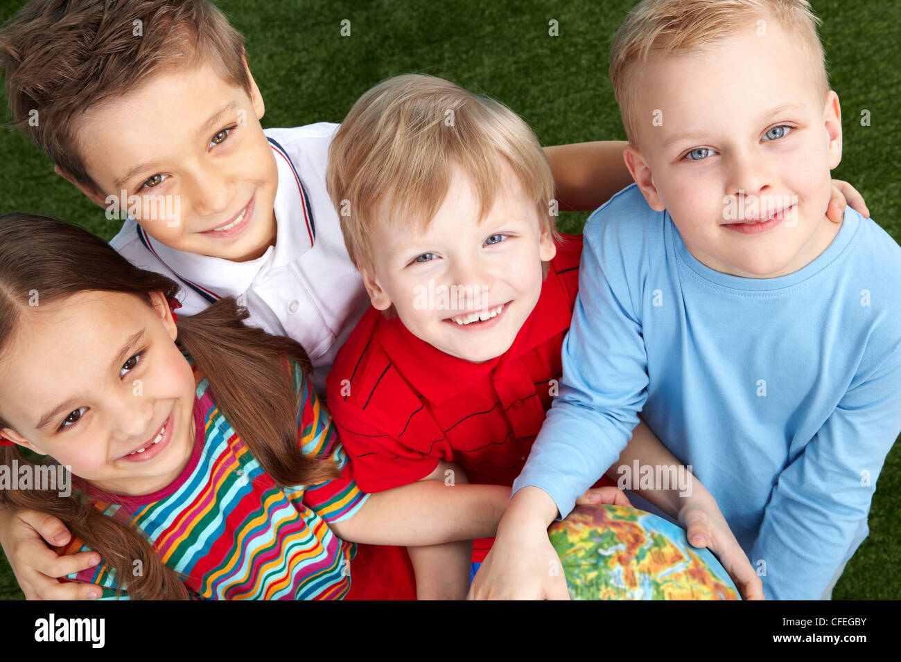Overview of four children looking up and smiling cheerfully Stock Photo ...
