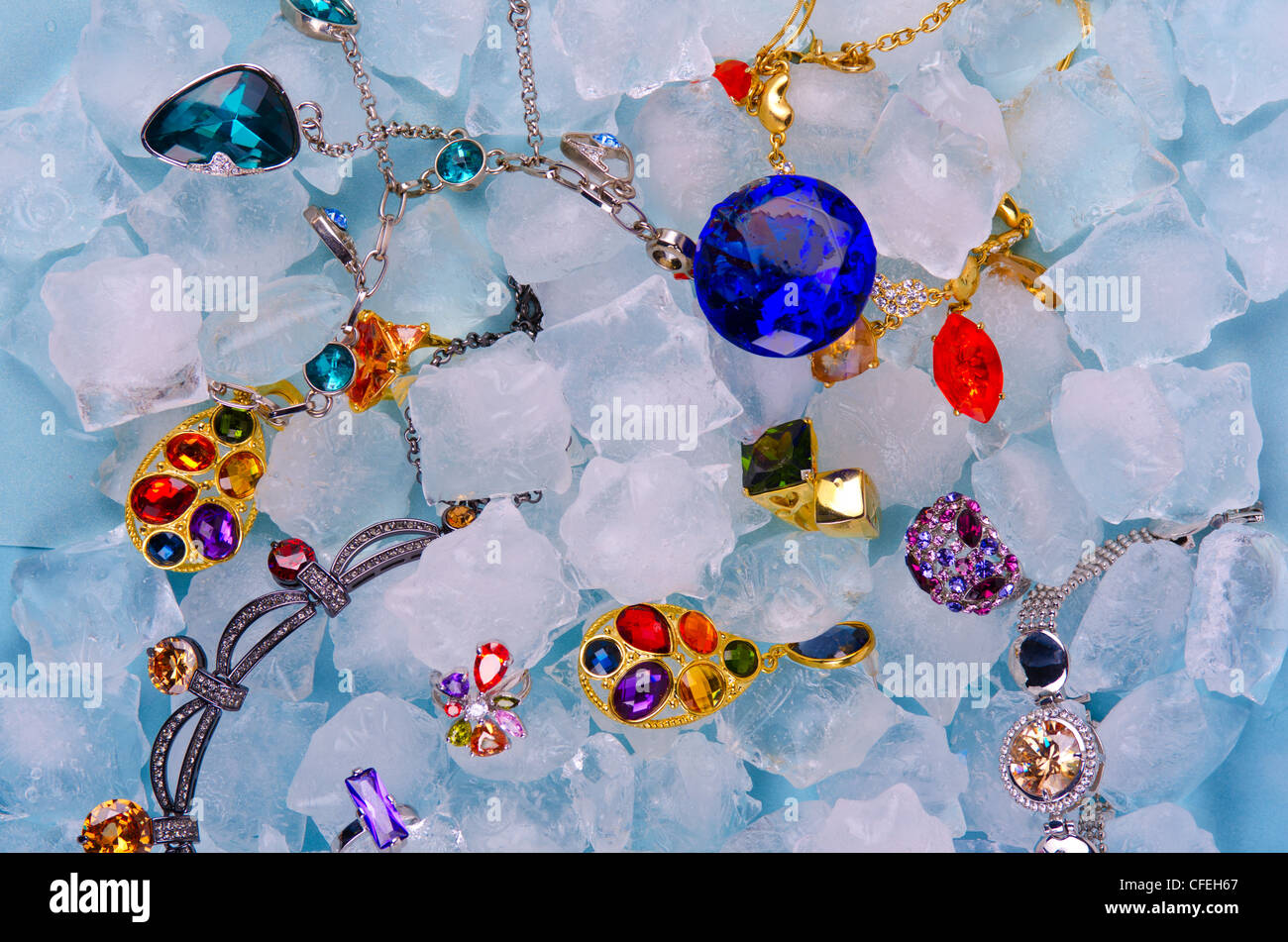 Jewels at blue cube of ice background Stock Photo - Alamy