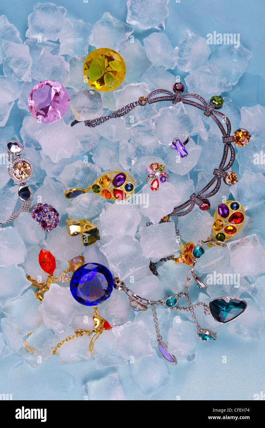 Jewels at blue cube of ice background Stock Photo - Alamy