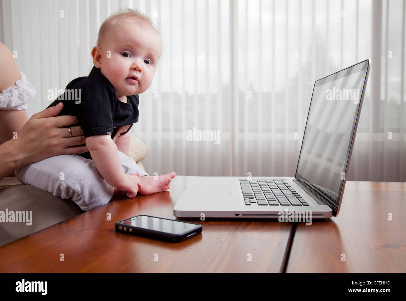 Baby with computer Stock Photo - Alamy