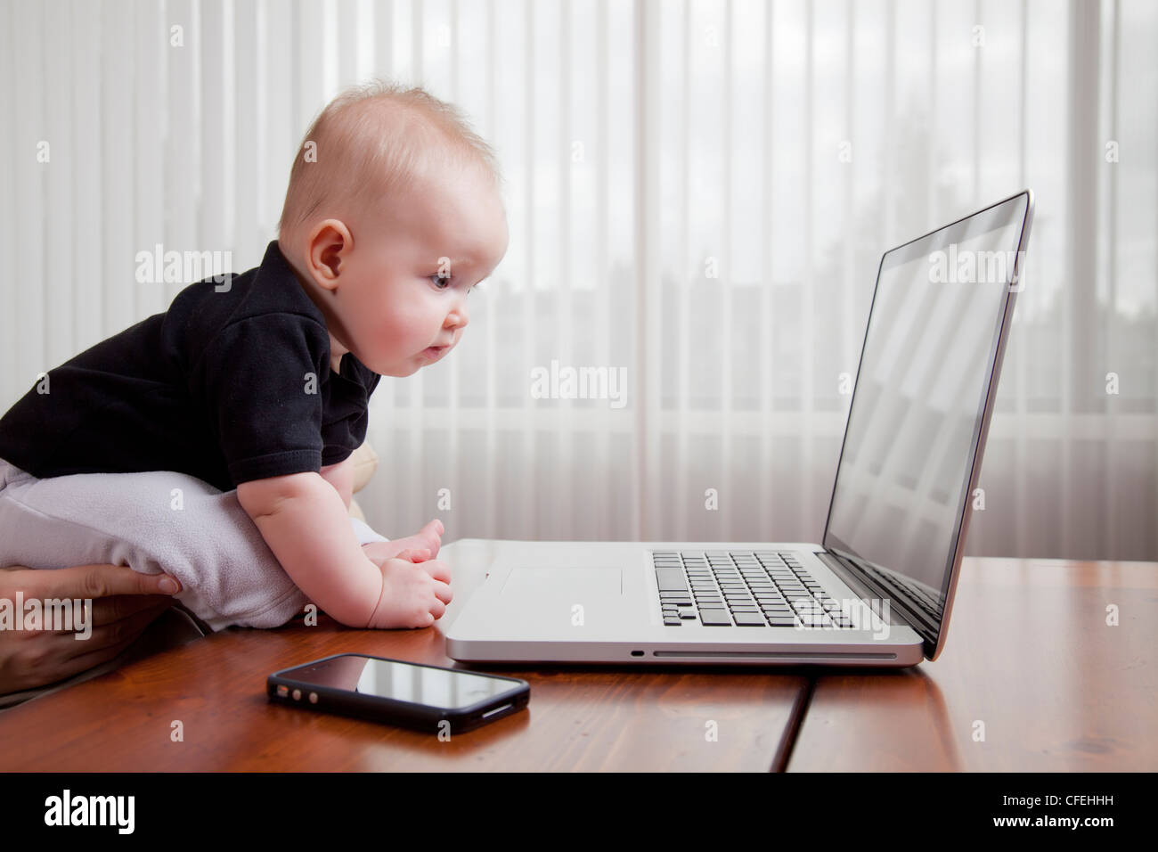 Baby with computer Stock Photo - Alamy