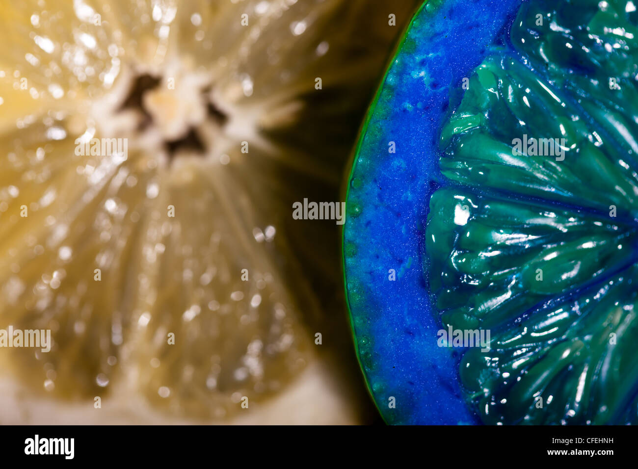 A slice of blue dyed lemon against a slice of normal lemon! Stock Photo ...
