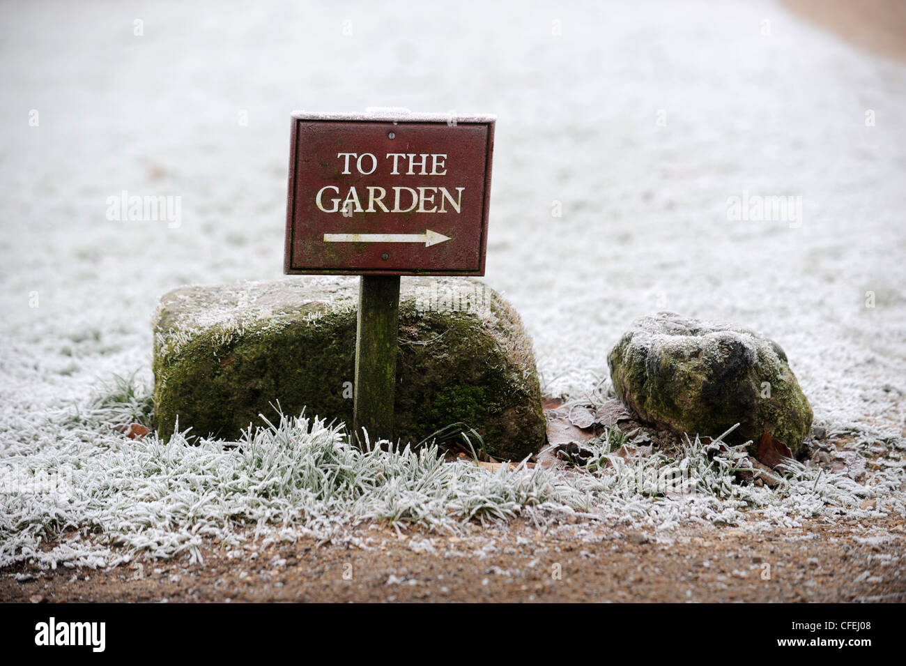 A sign pointing the way to an open garden on a frosty winter day in ...