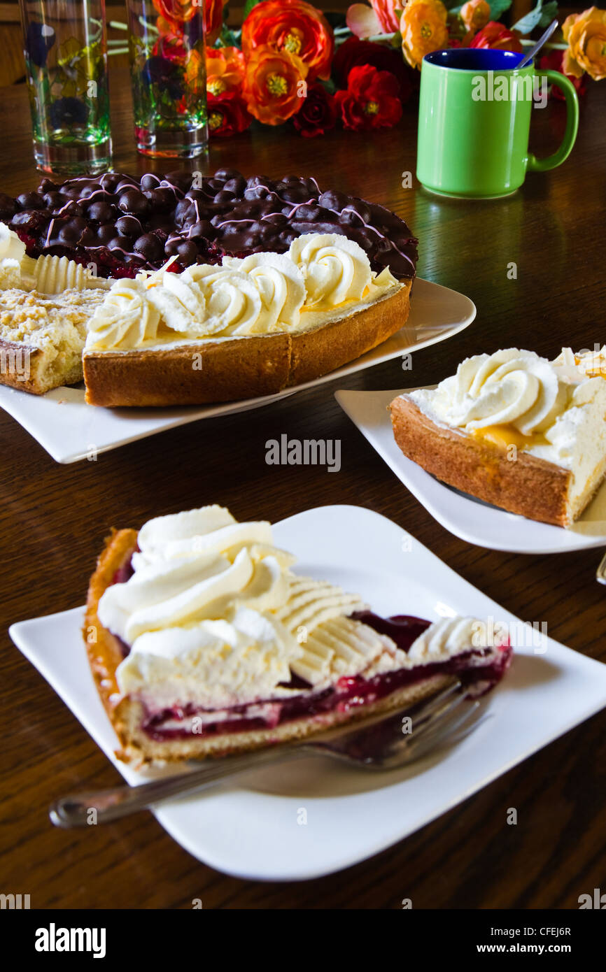 Different Dutch pastry or Limburgian flans with cups, mugs and flowers ...
