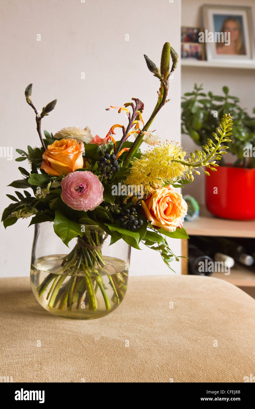 Bouquet of flowers with glass vase in modern interior Stock Photo - Alamy